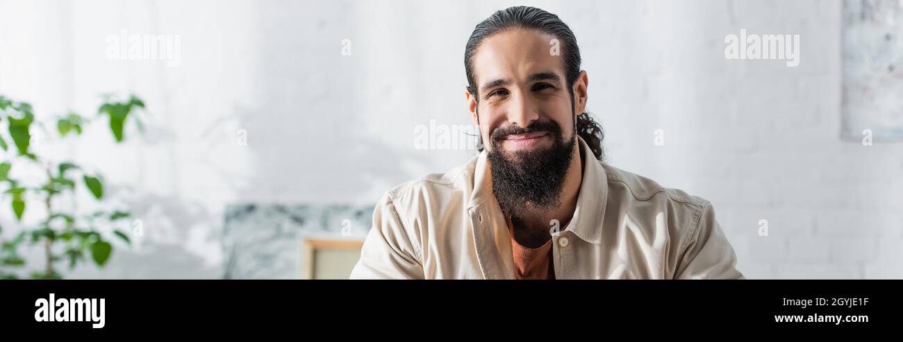 bearded hispanic man smiling while looking at camera, banner Stock ...