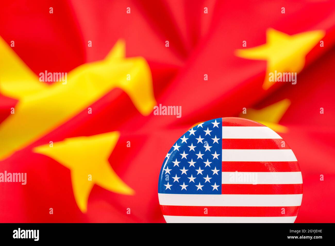 Stars and Stripes button set against yellow & red of China flag. For US ...