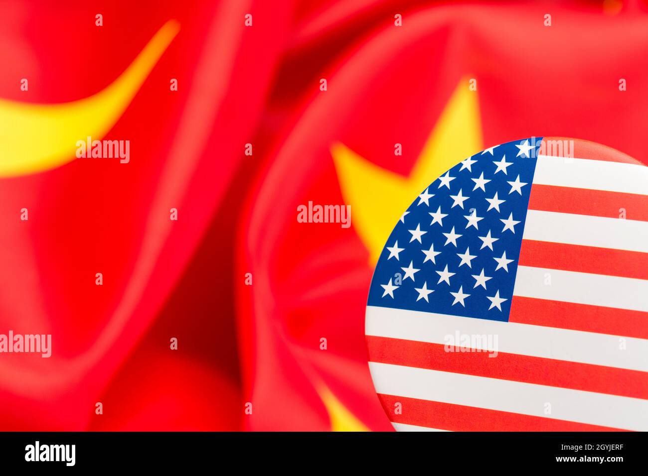 Stars and Stripes button set against yellow & red of China flag. For US ...