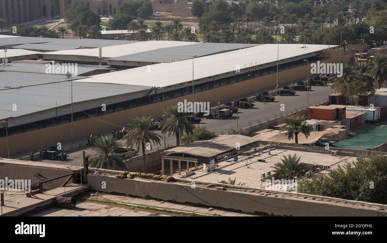 Iraqi Security Forces vehicles line up in the street outside the U.S ...