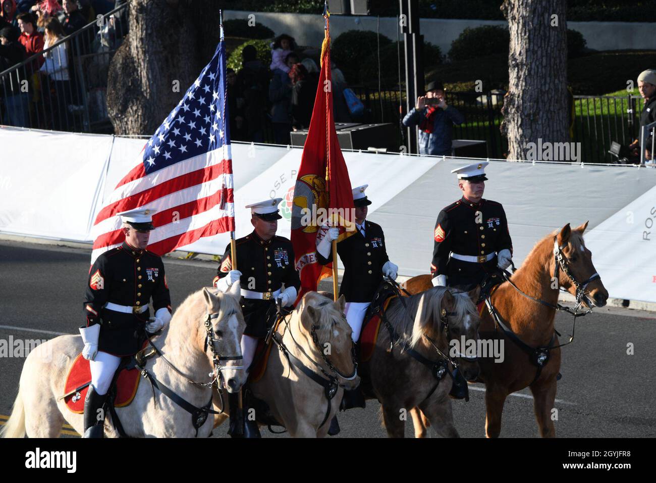 The Marine Corps Mounted Color Guard pass through the streets of ...