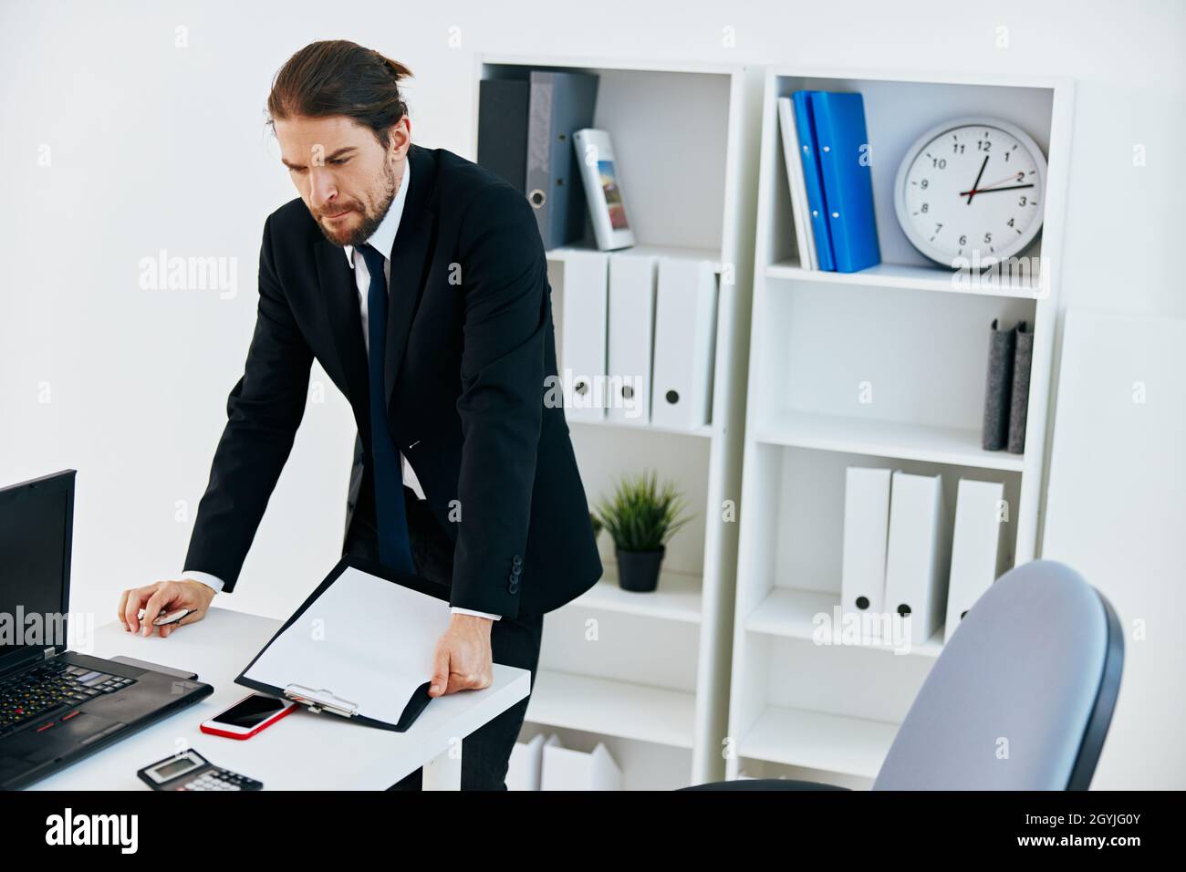 manager holding a phone telephone office lifestyle Stock Photo - Alamy