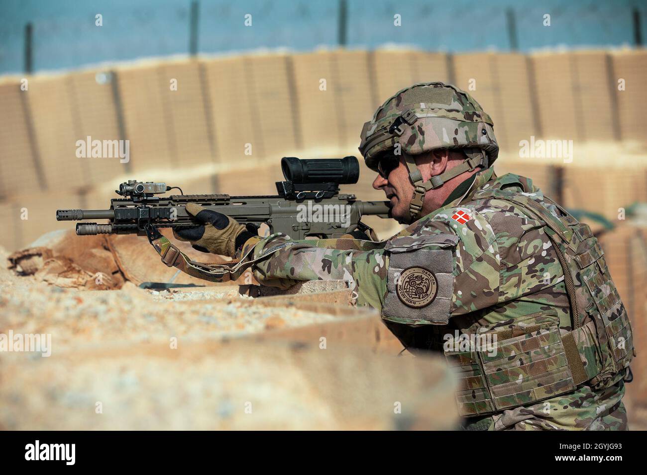 A Danish soldier scans his sector of fire during a base defense ...