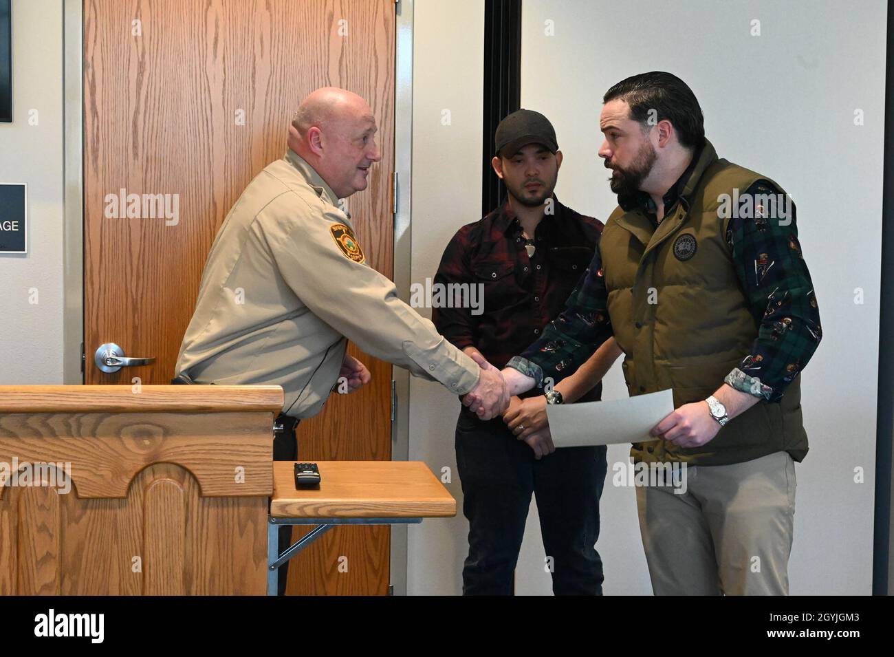 Ward County Sheriff Bob Roed, left, shakes hands with Tech. Sgt. Ryan ...