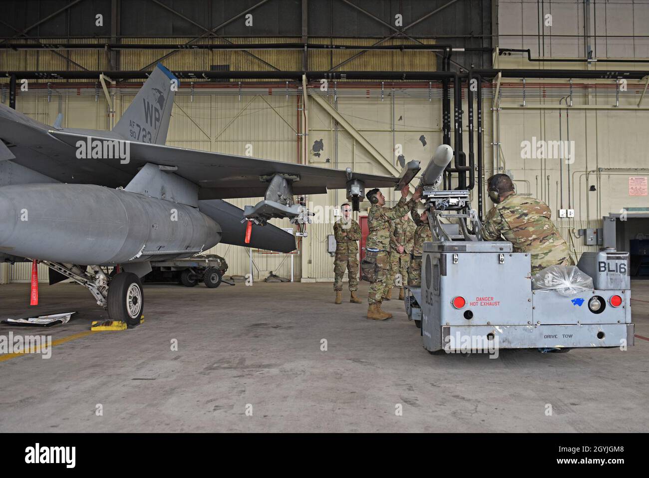 A 35th Aircraft Maintenance Unit load crew team loads an F-16 Fighting ...