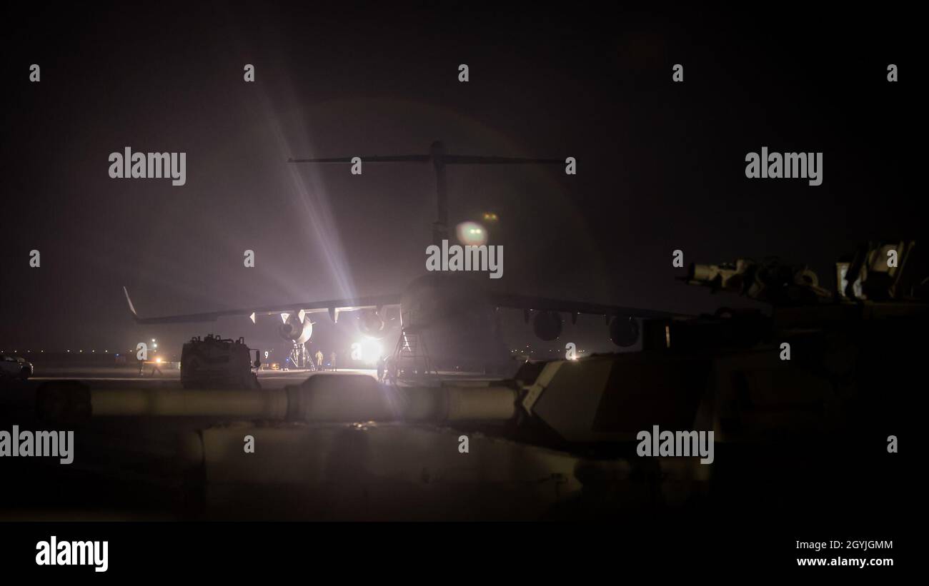 A U.S. Army M1A1 Abrams tank treads near a flight line in the U.S ...