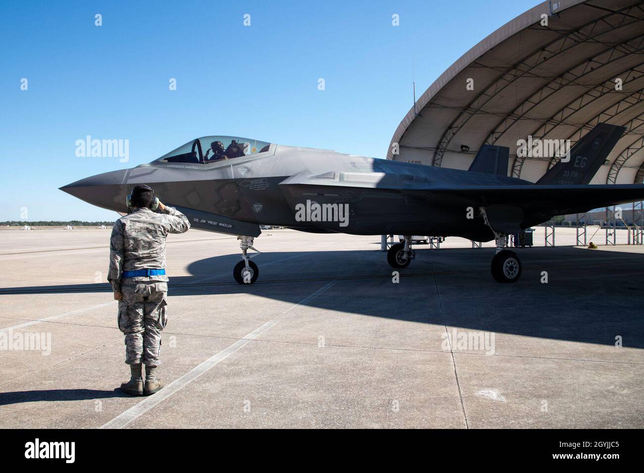 A crew chief from the 58th Fighter Squadron salutes a F-35A Lightning ...