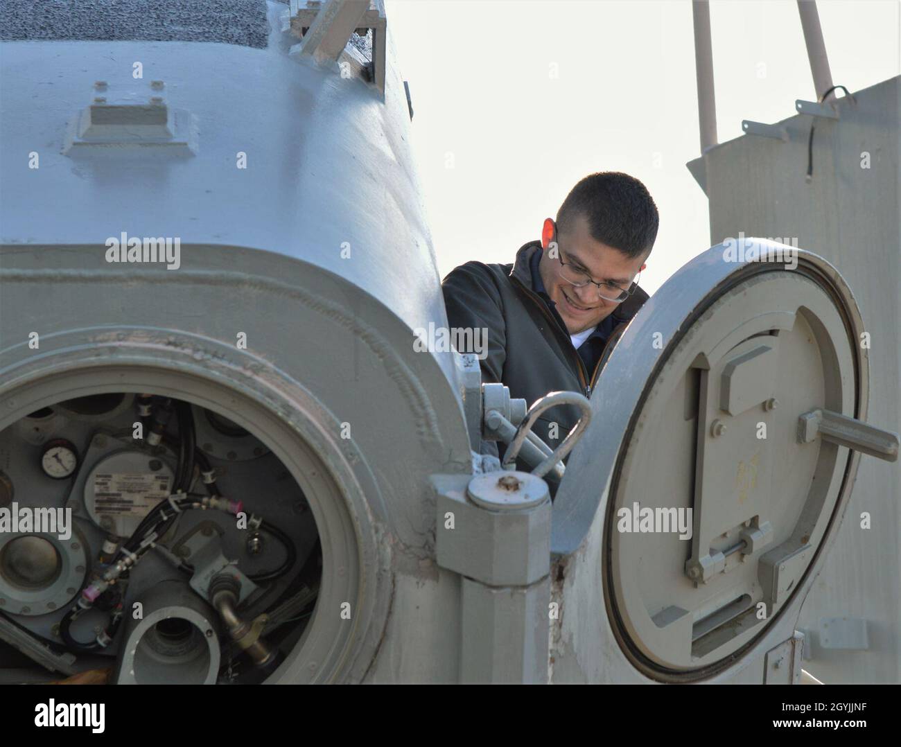 A U.S. Navy volunteer works on an open Mk. 143 Armored Box Launcher ...