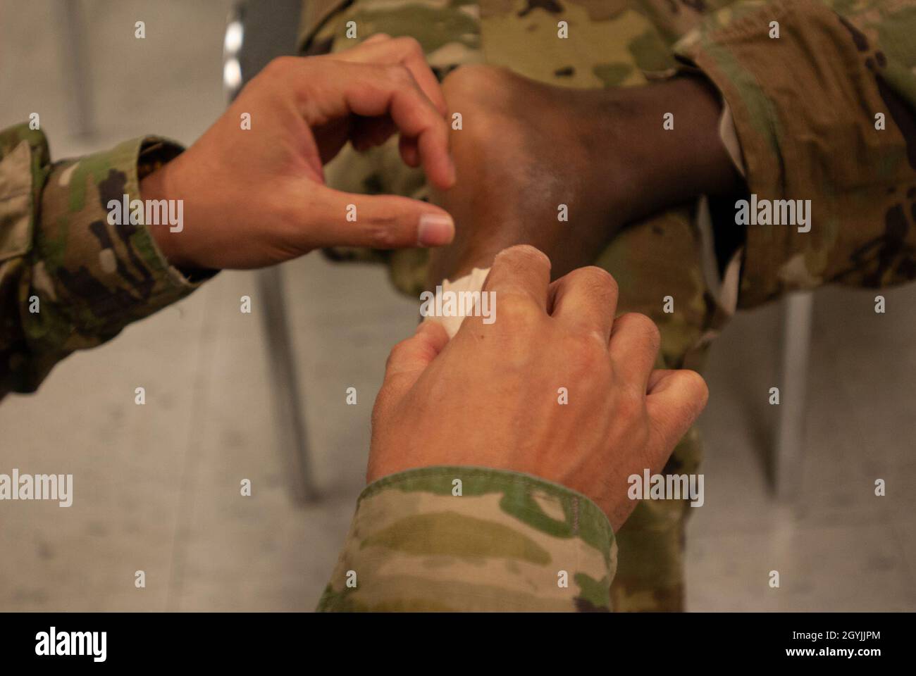 An Army Reserve medic checks the feet of a competitor following an 8 ...