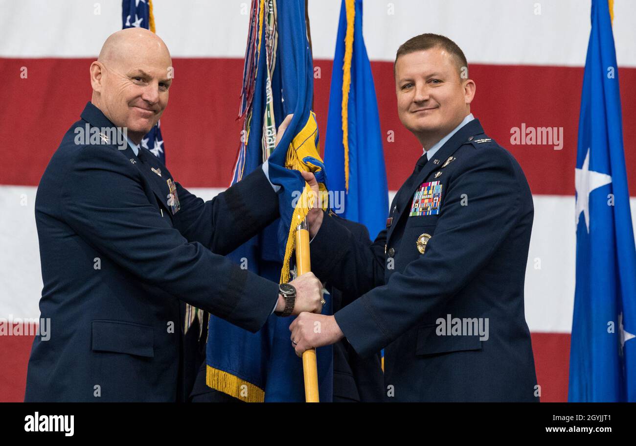 Maj. Gen. Sam C. Barrett, left, 18th Air Force commander, presents the ...