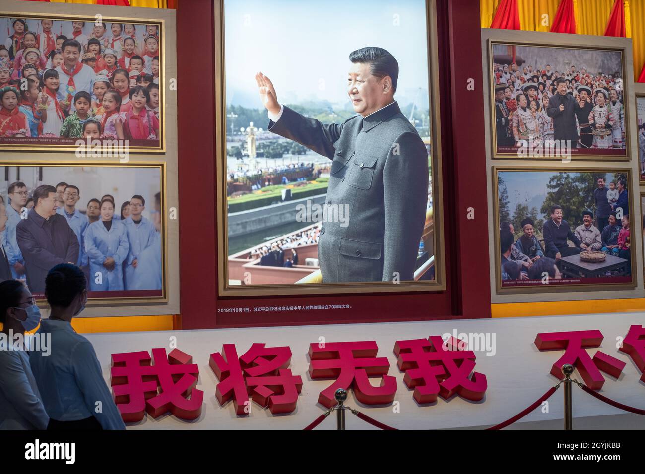People look at images showing Chinese President Xi Jinping at the ...