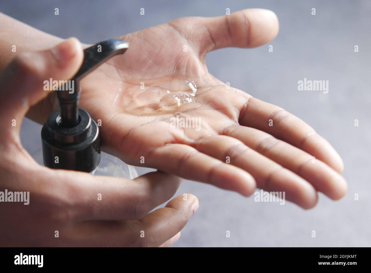 Using sanitizer liquid for preventing corona virus Stock Photo - Alamy