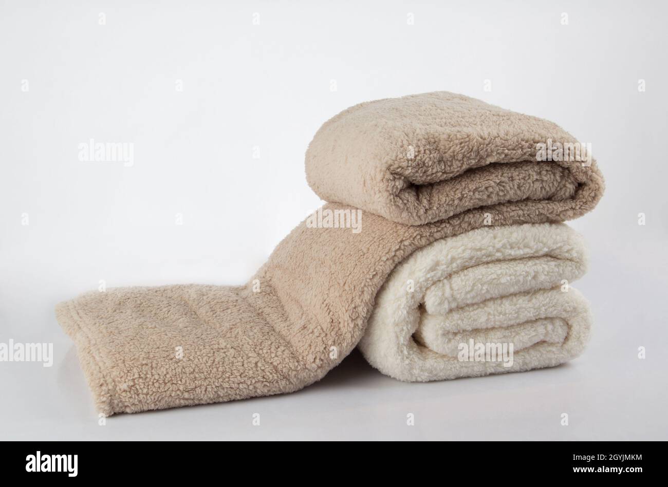 Soft and warm stack of folded blankets isolated on white background ...