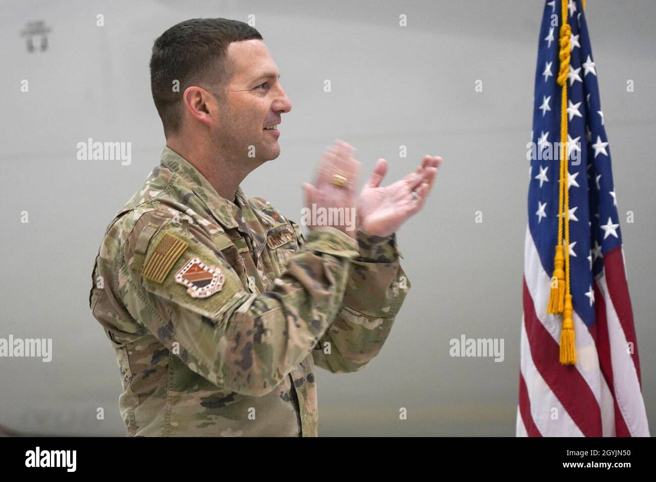 Air Force Col. Robert Davis, 3rd Wing commander, applaudes in an ...