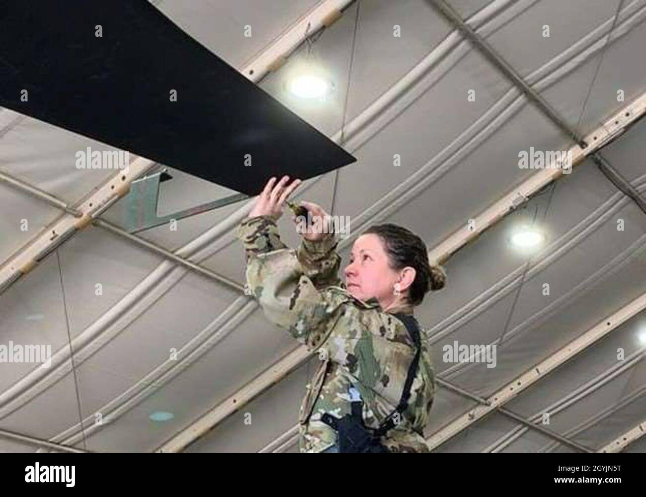 Staff Sgt. Tracey Emily, 1107th Aviation Group, prepares an AH-64E ...