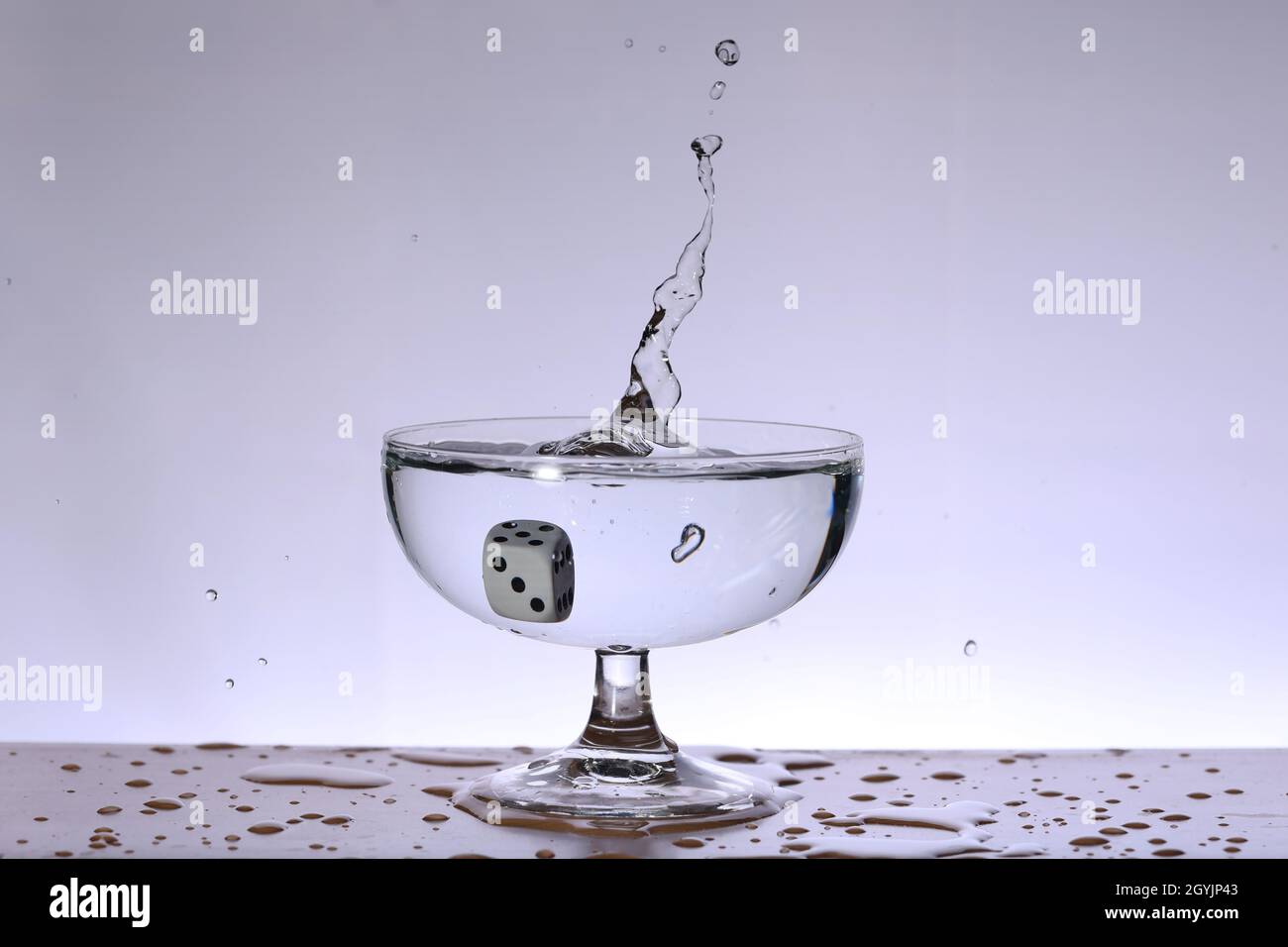 Dice falling into the water with splashes Stock Photo - Alamy
