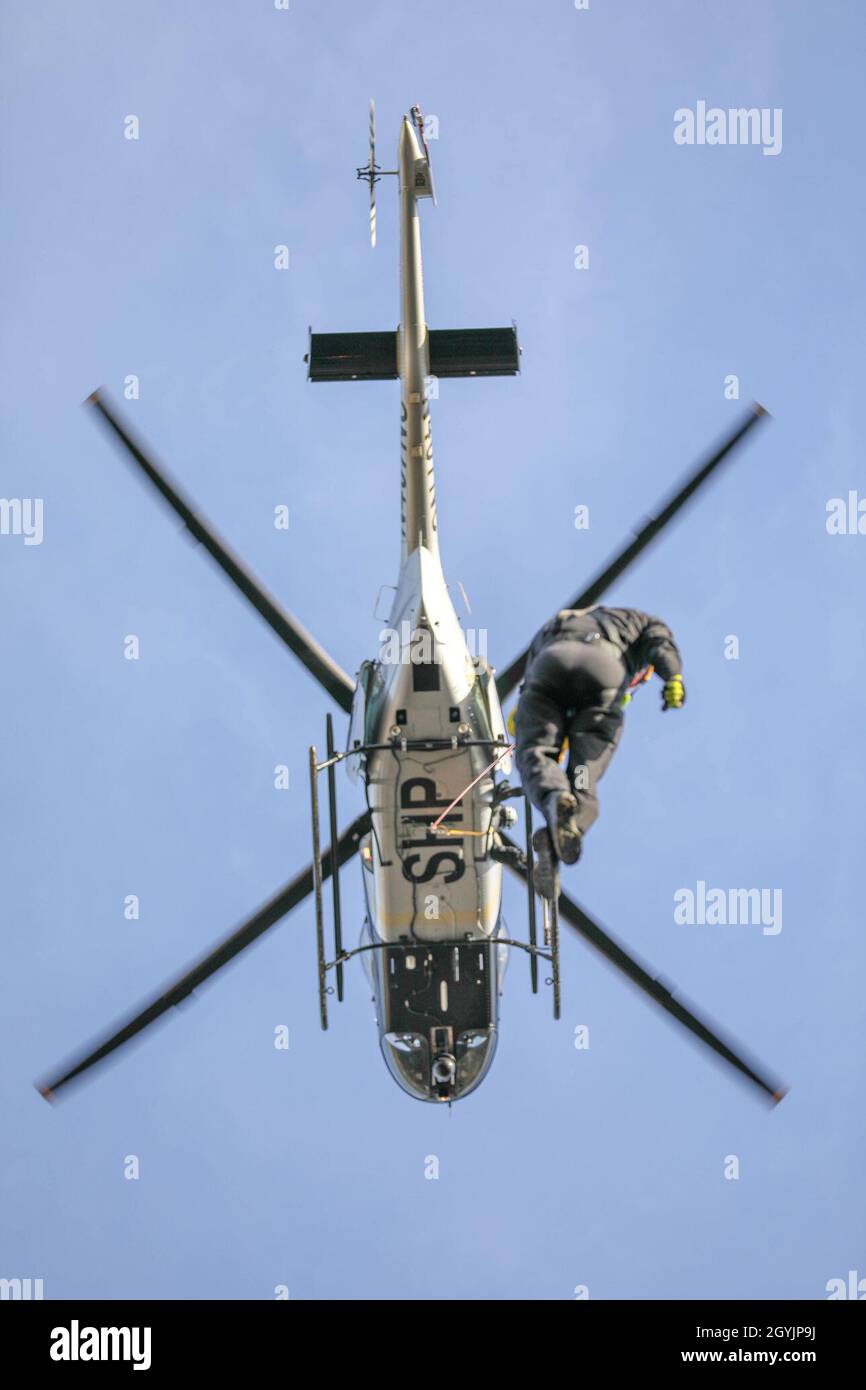 A North Carolina Helicopter Aquatic Rescue Team (NCHART) technician is ...