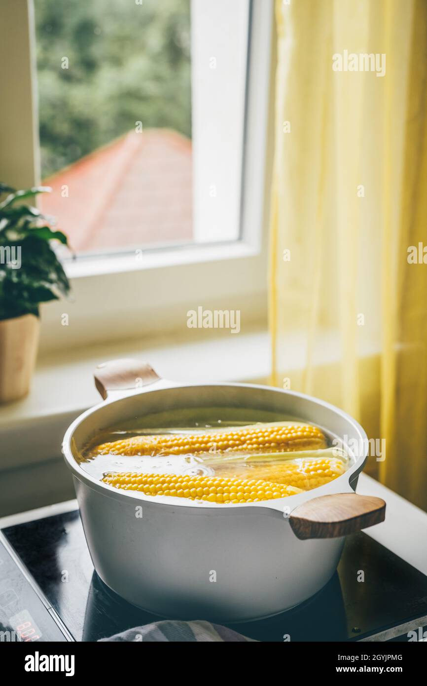 Fresh corn cobs boiling in hot water on stove Stock Photo - Alamy
