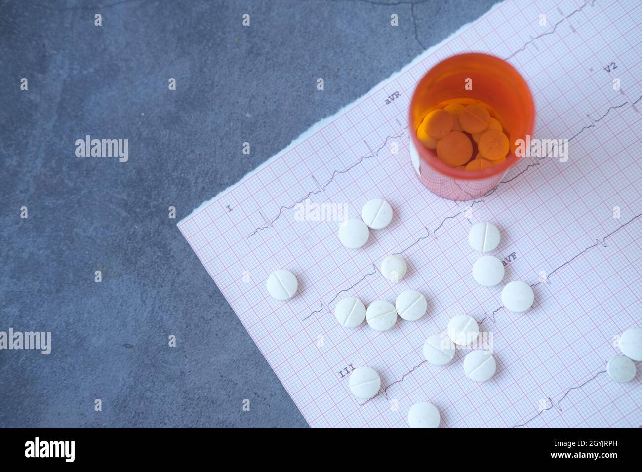 medical pills and container on a cardio diagram Stock Photo - Alamy
