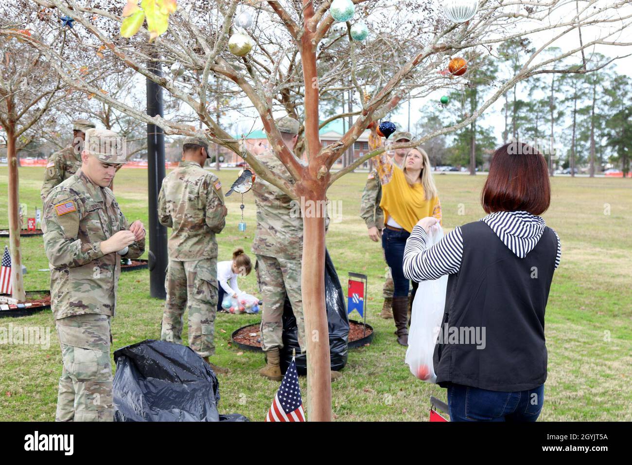 Soldiers and families clean the trees of fallen soldiers at Warriors ...