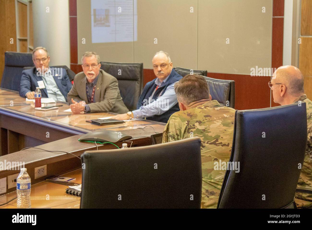 Mike Sutton, (second from left), director of the Alaska Division of ...