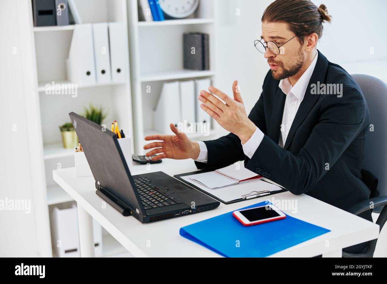man in a suit documents work office laptop lifestyle Stock Photo - Alamy