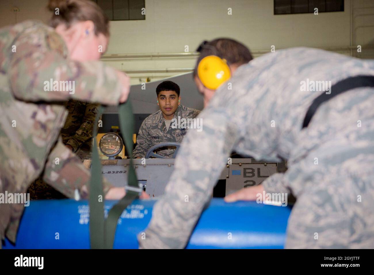 Load crew members from the 9th Aircraft Maintenance Unit prepare to ...