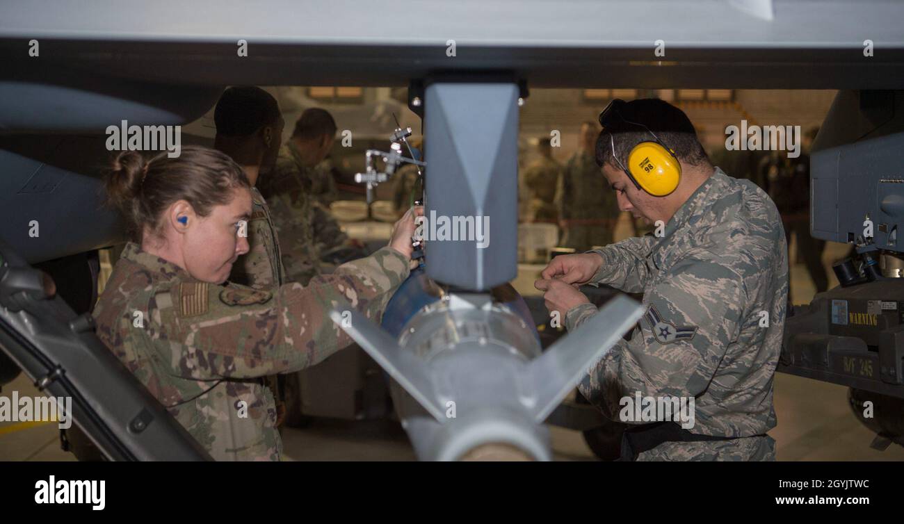 Load crew members from the 9th Aircraft Maintenance Unit prepare to ...
