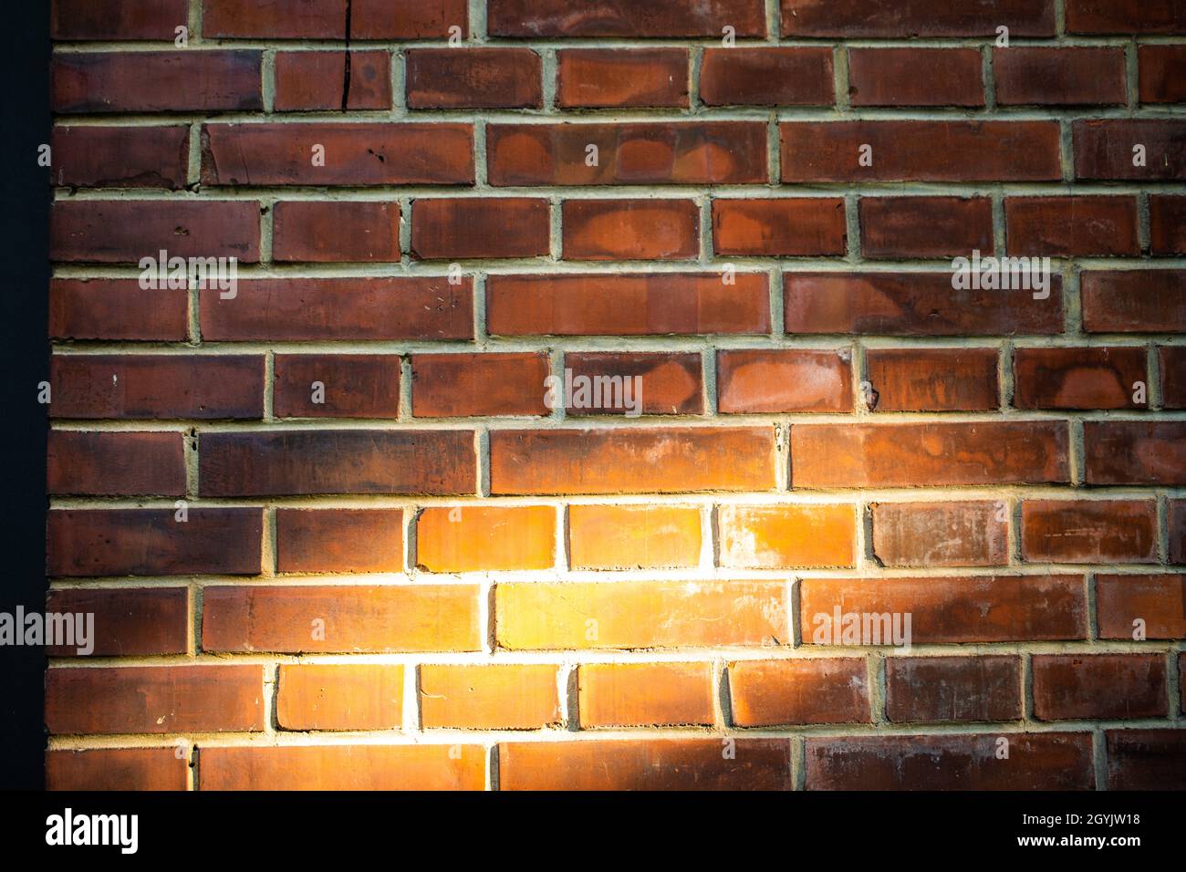 Brick wall with sun as a background Stock Photo - Alamy