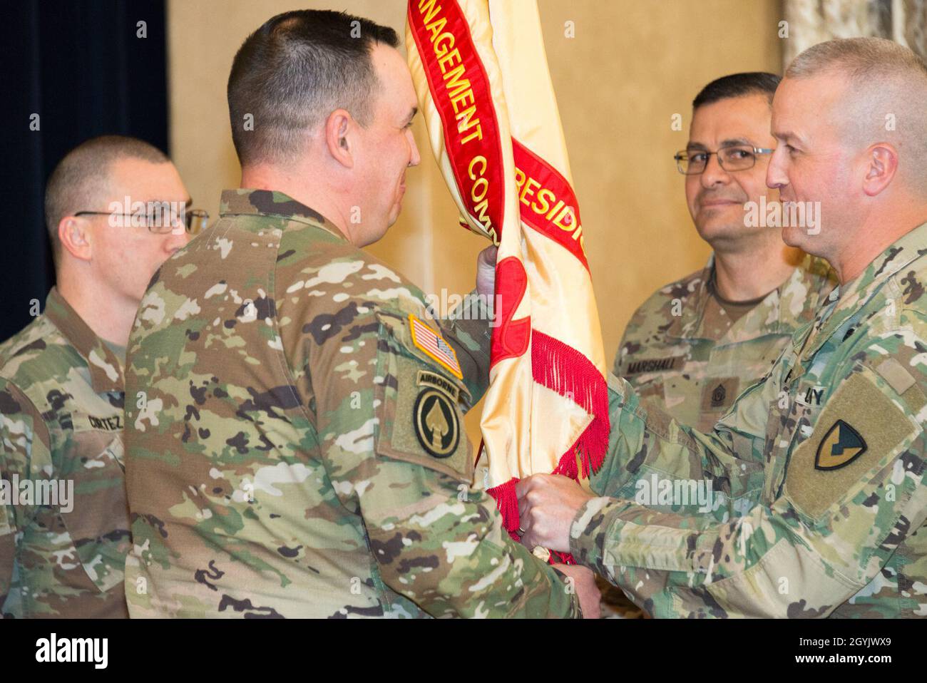 Incoming Command Sgt. Maj. Robert N. Londers recieves the unit colors ...