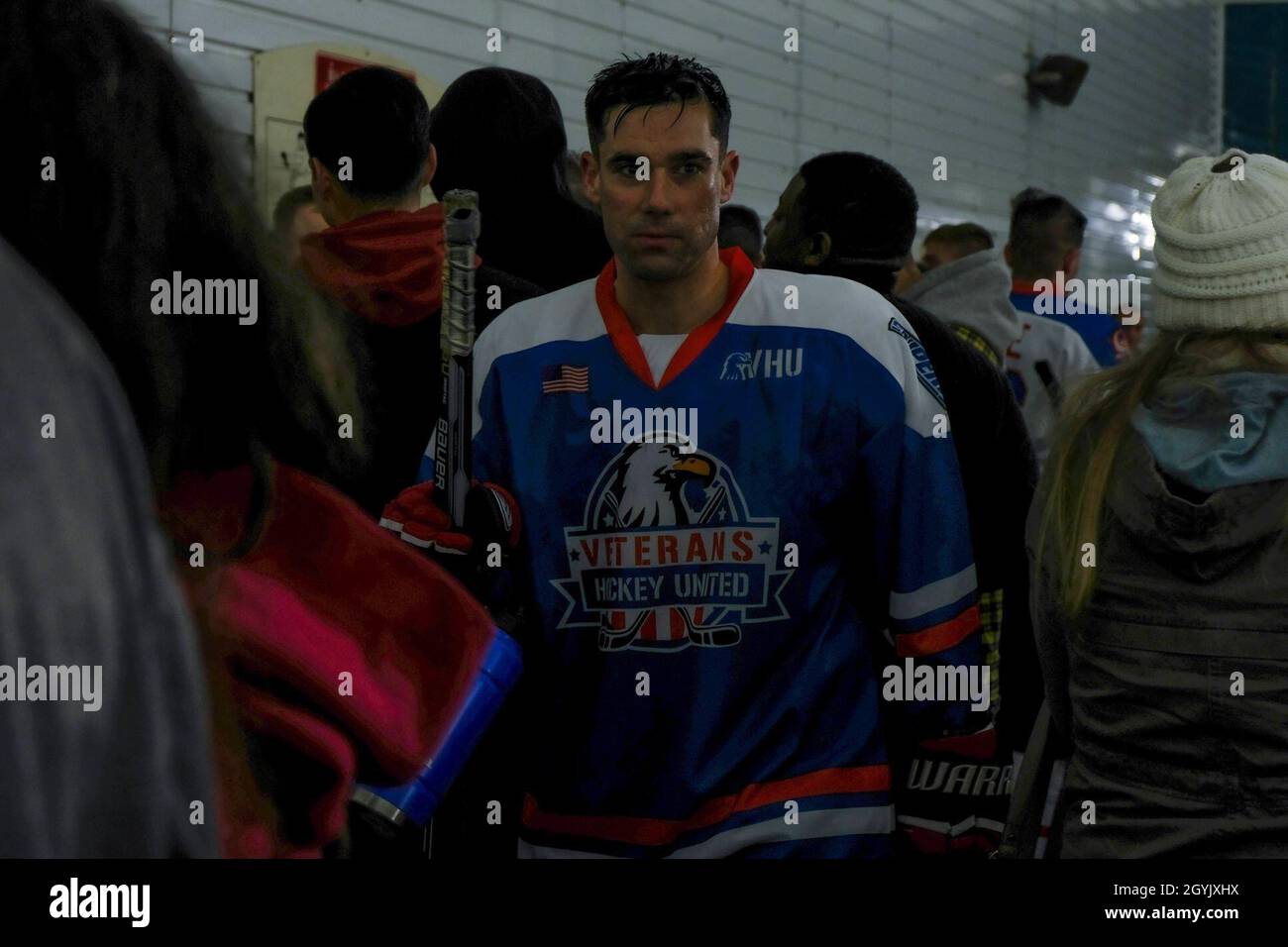 U.S. Marine Corps Capt. Ryan Nowak makes his way through spectators ...