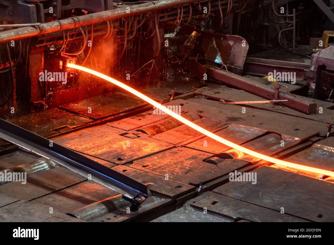 Red-hot metal billet on the roller table of a rolling mill Stock Photo ...