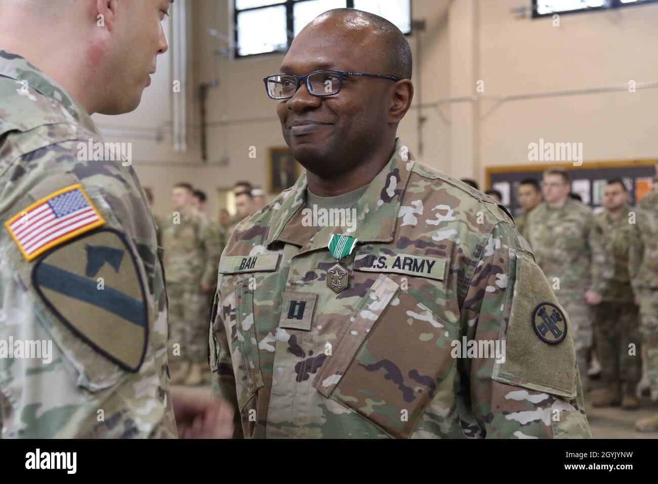 Capt. Sulaiman Bah receives an Army Commendation Medal to recognize his ...
