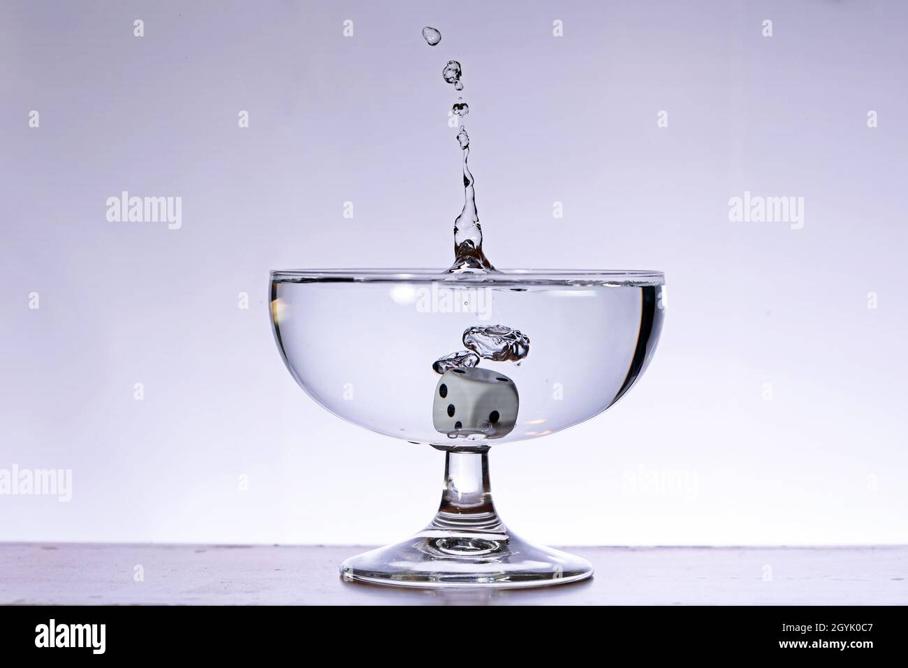 Dice falling into the water with splashes Stock Photo - Alamy