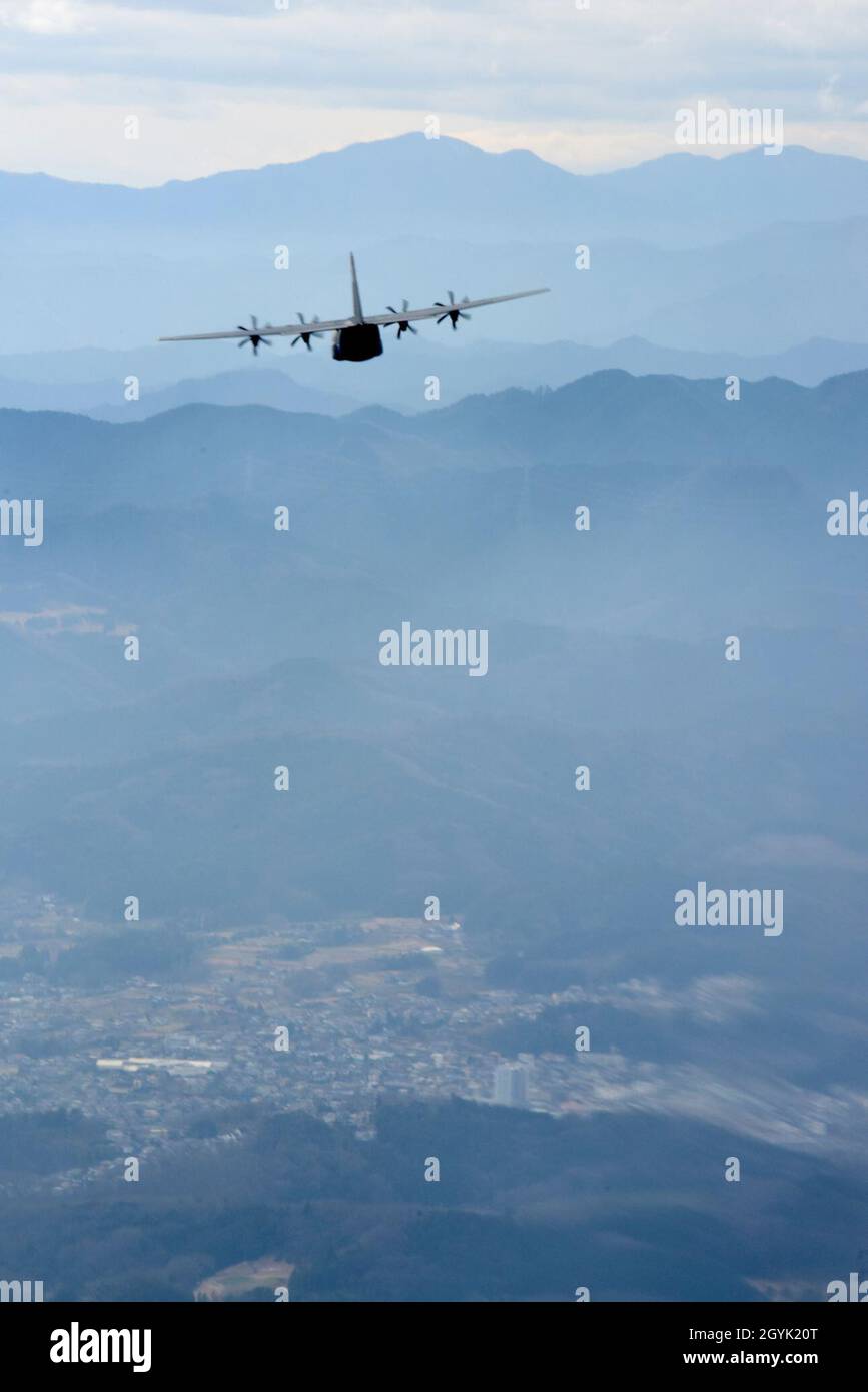 A C-130J Super Hercules in a three-aircraft formation navigates ...