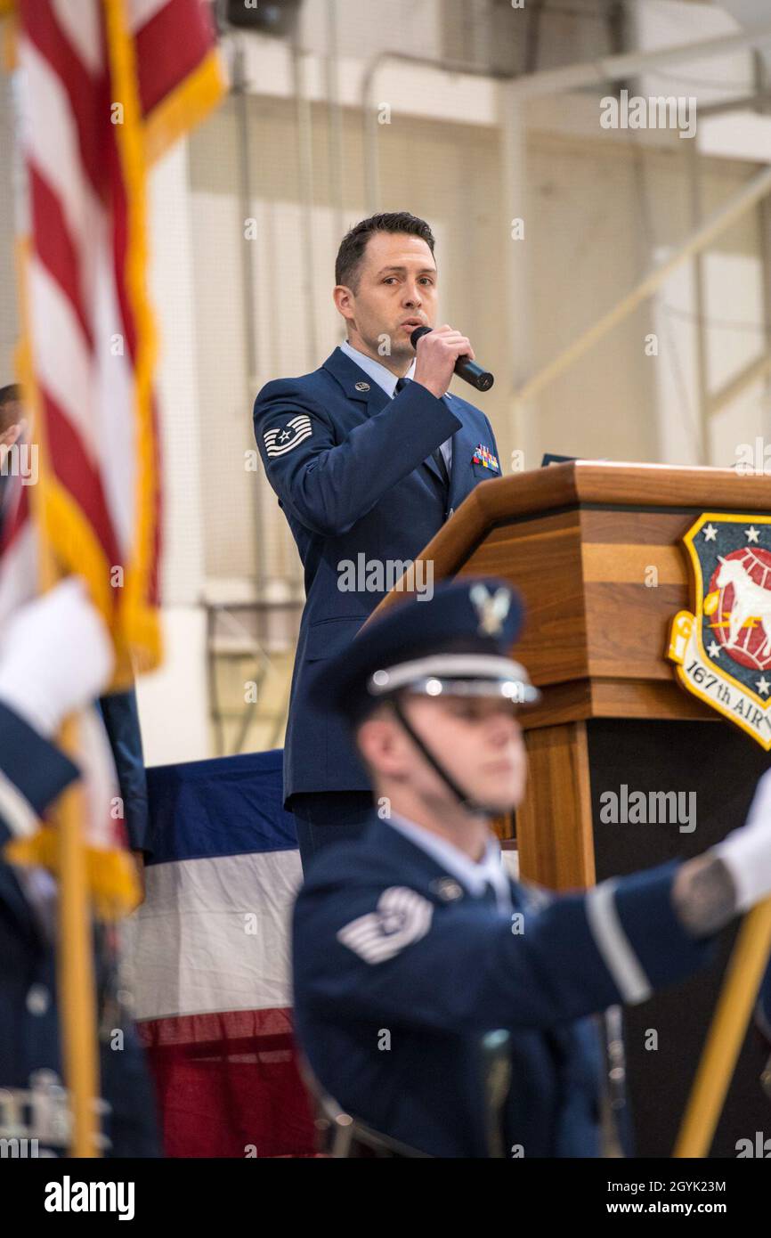 Tech. Sgt. Joshua Robins sings the national anthem flag at the start of ...