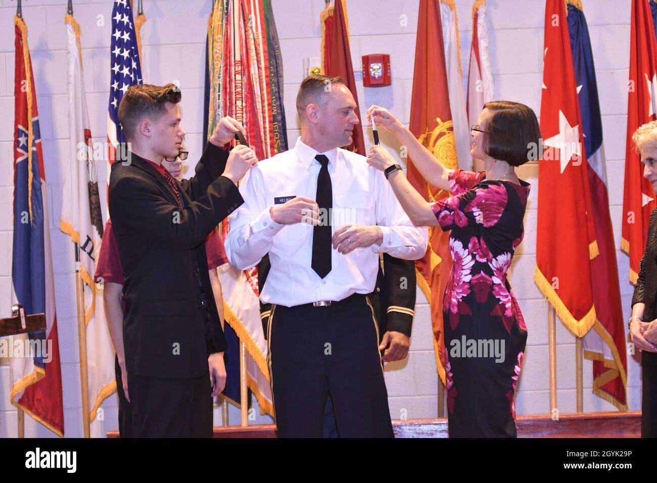 Brig. Gen. Jered P. Helwig stands as his son, Nathan, and his wife ...