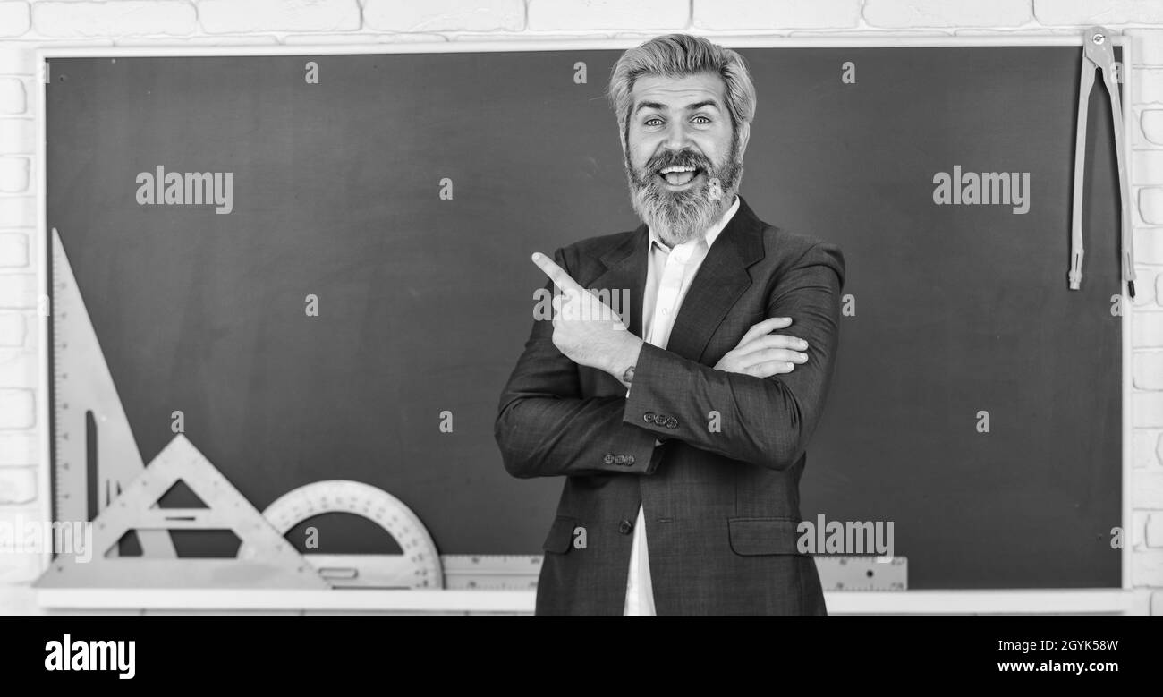 Teacher explain hard topic. Man teacher in front of chalkboard ...