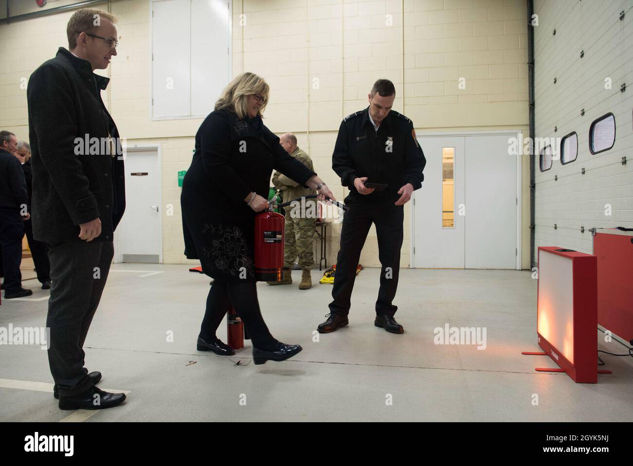 A local civic leader tests a fire extinguisher simulator at the RAF ...