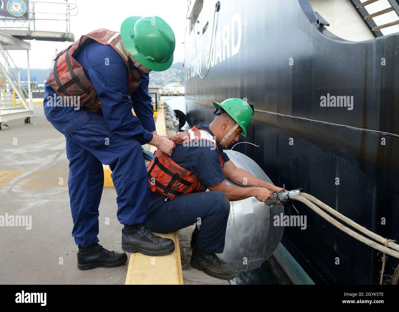 Crew members from the Coast Guard Cutter Walnut (WLB 205) remove the ...