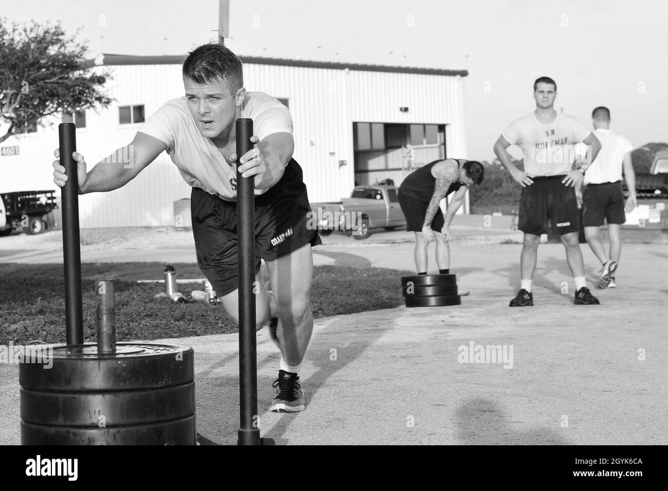 Seaman Dan Fendius pushes a weighted sleigh during his workout in ...