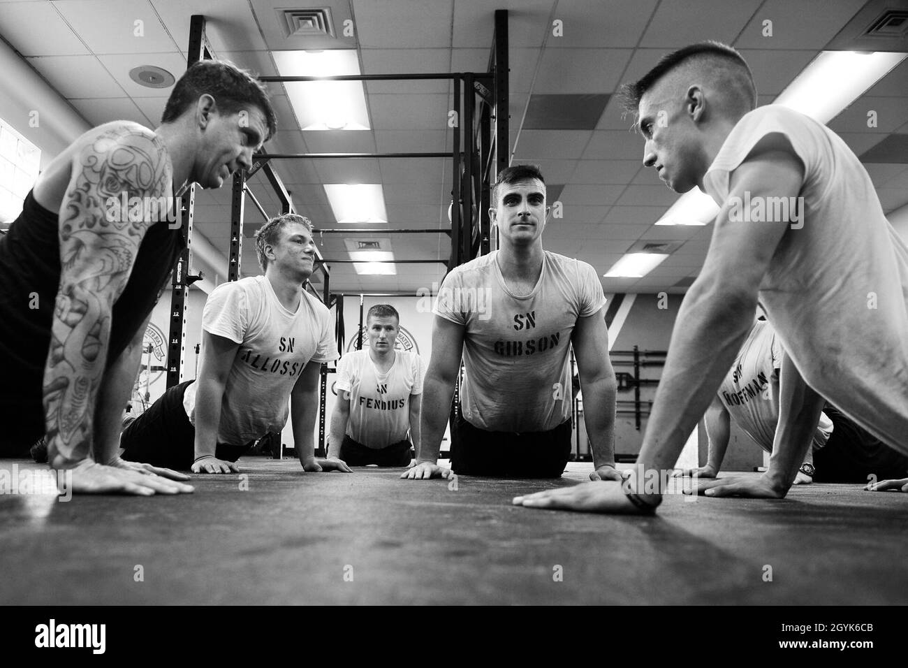 Coast Guard members stretch after a workout in preparing to become ...