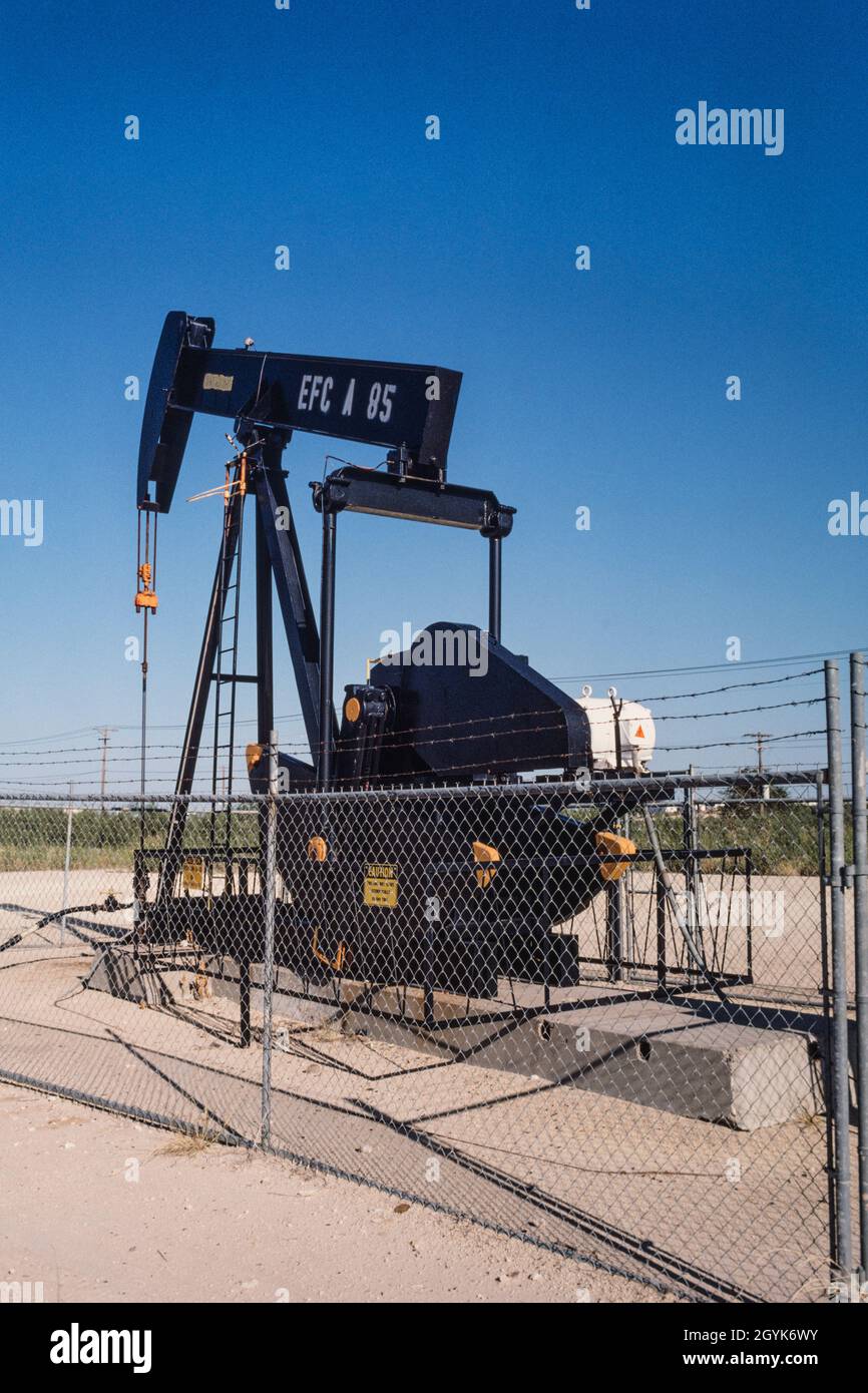 An oil field pumpjack pumps crude oil out of an oil well in the Permian ...