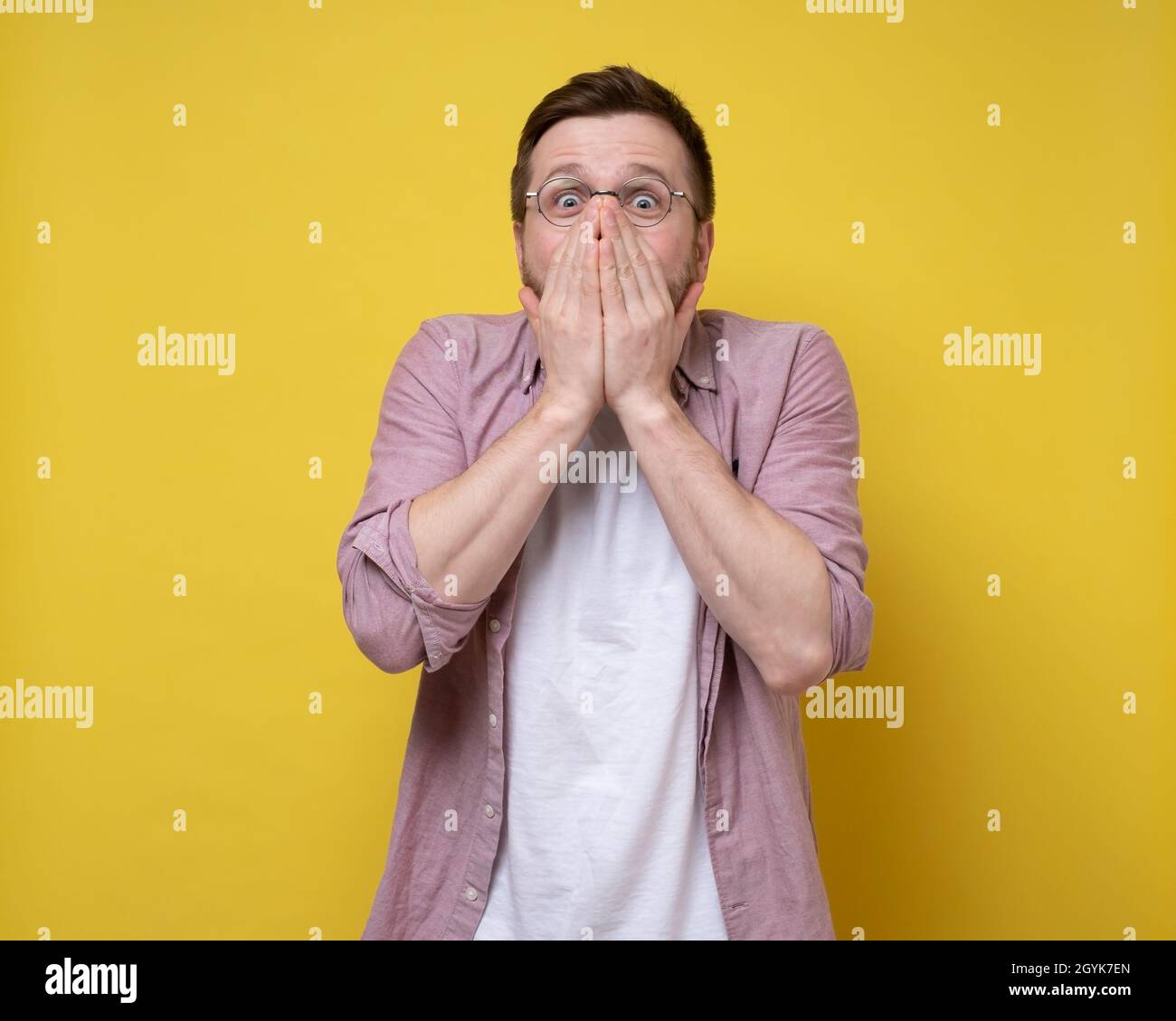 Man with glasses is shocked by a pleasant surprise, he is very ...