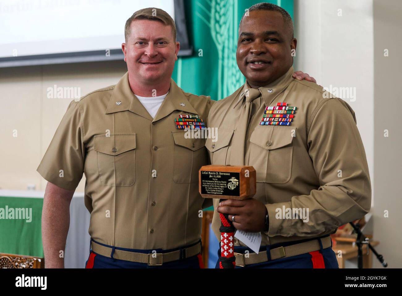 U.S. Marine Corps Lt. Col. Kenric Stevenson, right, receives a gift ...