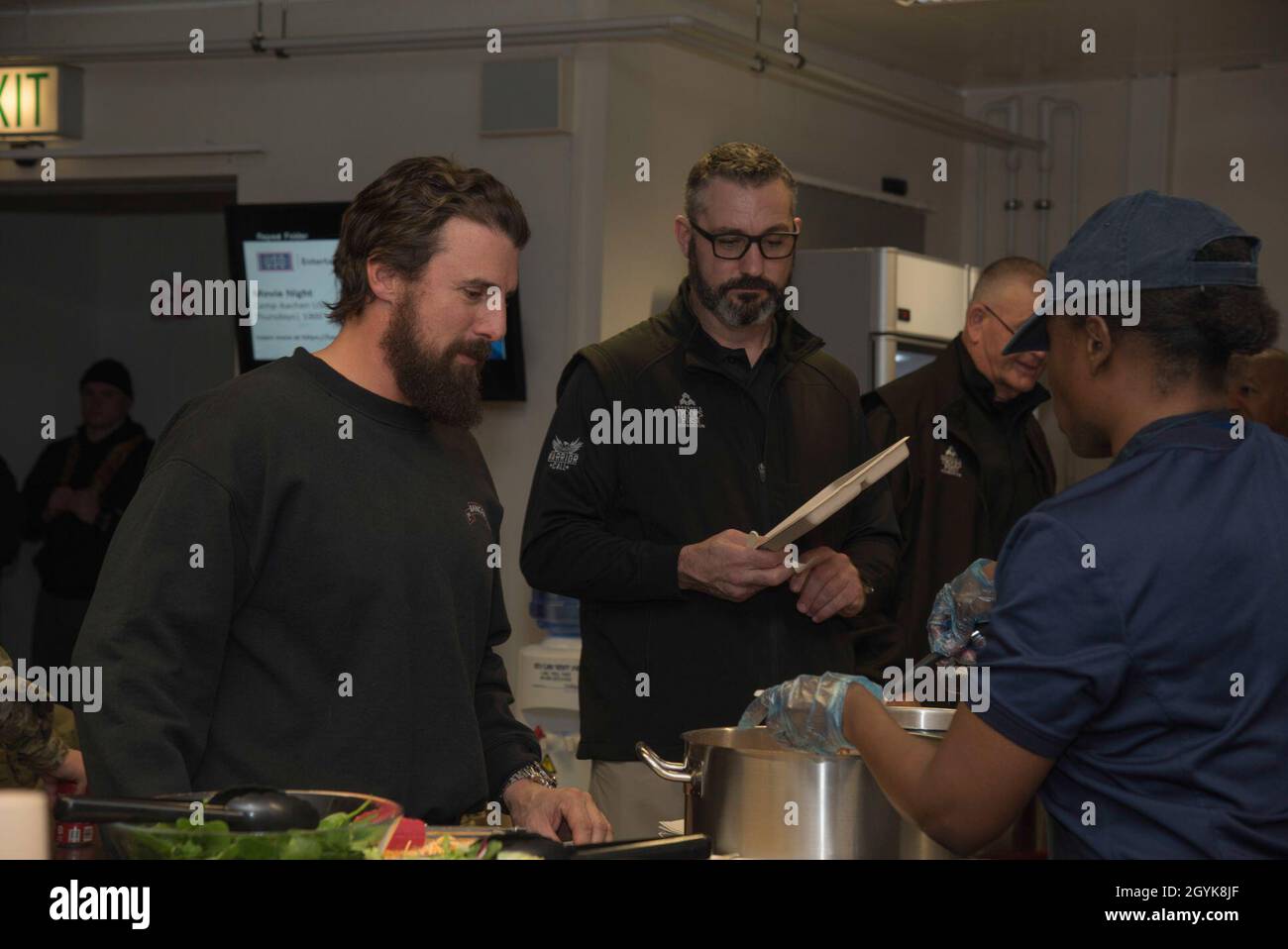 U.S. Army Master Sgt. (ret.) Chris Corbin gets served a bowl of chili ...