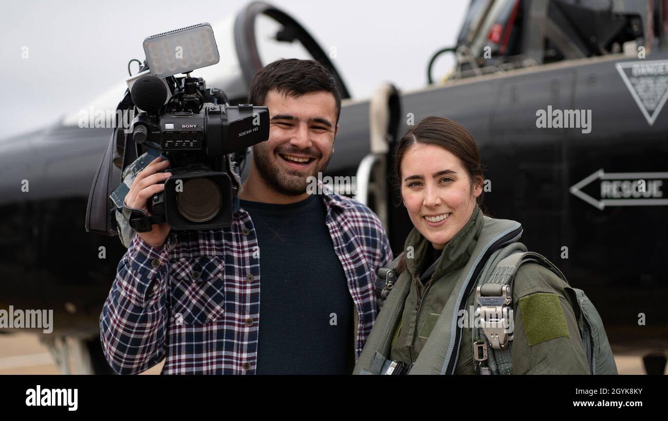 Local news reporters, Madeline Schmitt and Scott DePuy, pose for a ...