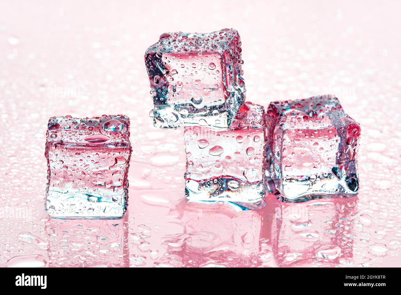 Ice cubes on pink background Stock Photo - Alamy