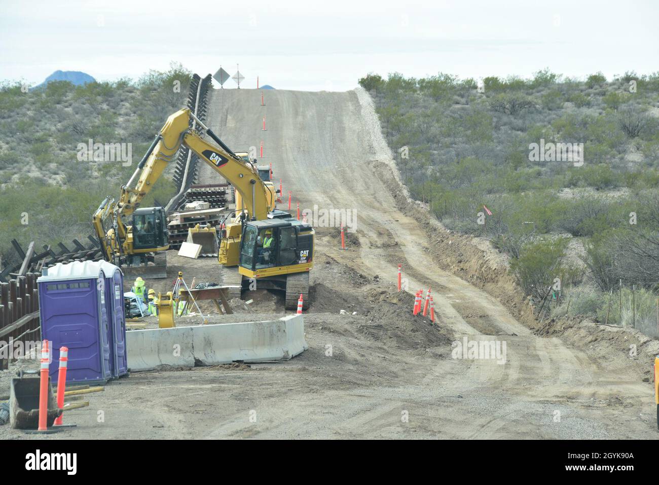 Construction crews construct a culvert box to help direct the flow of ...