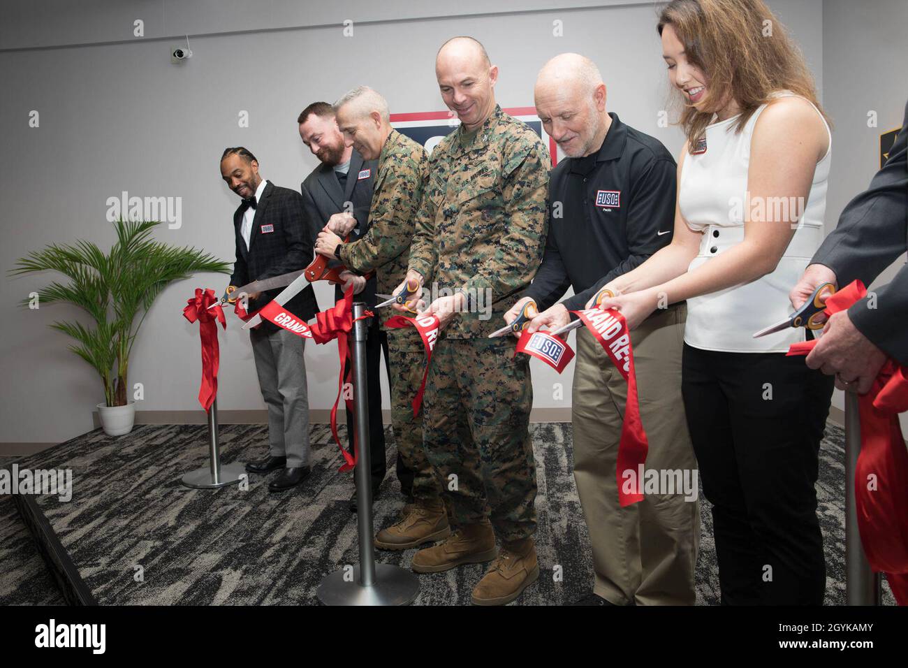 U.S. Marines and members of the United Service Organizations (USO) cut ...